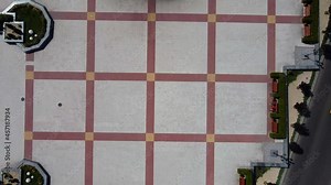 View of white squares and red straight lines in the square. Paving slabs with patterns. Drone Video. Top down view. Uman. Ukraine. Europe