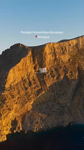 Ever seen a monastery carved into a cliff glowing in golden sunrise light? ✨ High above the Aegean, hidden on the rugged cliffs of Amorgos, the Monastery of Hozoviotissa feels like it was placed between heaven and sea. As the first rays of the sun paint the white walls in gold, silence wraps the island, so peaceful, it feels almost unreal. 🌅 The Panagia Hozoviotissa Monastery is a Greek Orthodox monastery on the island of Amorgos. It is built on the steep south coast of the island, at an altitu