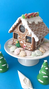 Create a holiday centerpiece with this beautiful gingerbread house! Satin Ice isomalt crystals create crystal clear windows and is perfect for instantly gluing pieces together, while our royal icing adds elegant piping and snowy details. ❄️ Shop both at SatinIce.com | Satin Ice | Facebook