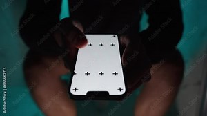 In the Dim Blue Light, a Man on the Toilet Is Scrolling Sideways on a White Screen on His Smartphone. Chroma Key Layout, Use the White Screen for Copy Space.
