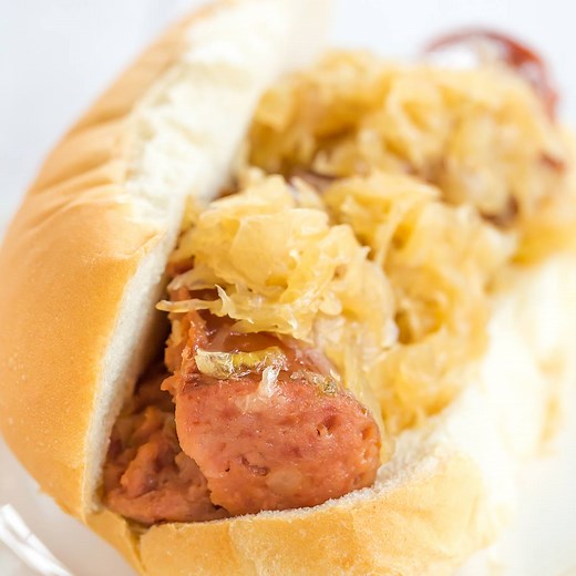 SLOW COOKER KIELBASA & SAUERKRAUT - Only 4 ingredients and 5 minutes prep time! The absolute BEST kielbasa and sauerkraut you'll ever eat, a huge crowd favorite! RECIPE >> https://www.browneyedbaker.com/beer-brown-sugar-kielbasa-with-sauerkraut/ | Brown Eyed Baker