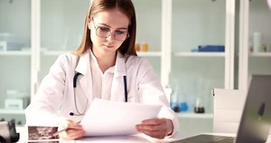 clip-1103202879-professional-doctor-examines-patient-test-results-office