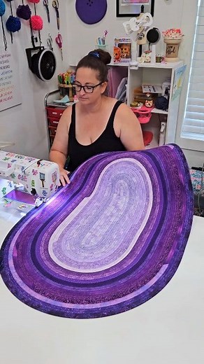 Today's custom Jelly-Roll Rug will be Texas bound. 💜 Pattern: Jelly-Roll Rug by RJ Designs Fabric: Amethyst Royale Jelly-Roll The green tool I am using is the Fabric Tube Maker from Clover. #jellyrollrug #sewing #handmade | Uniquely Mateo