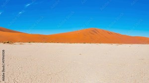 Panorama on colorful sand dunes and scenic landscape at Sossusvlei in the Namib desert, Namib Naukluft National Park, tourist destination in Namibia. Travel adventures in Africa.