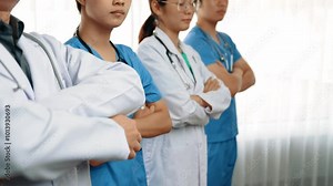 Confident and professional team of medical staff stand in line together as healthcare service and doctor leadership at hospital. Teamwork lead to successful medical treatment.Slow motion. Rigid.