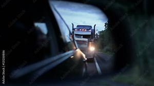 rear view mirror footage of large truck on a highway.