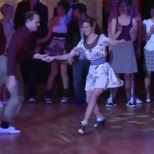 Dynamic Swing Dance Routine in a Lively Hall