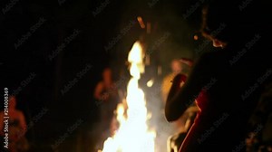 Women dancing around the fire at night