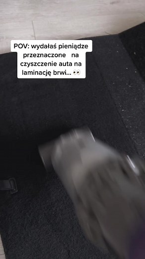 Handheld Vacuum Cleaner in Action on Dark Carpet