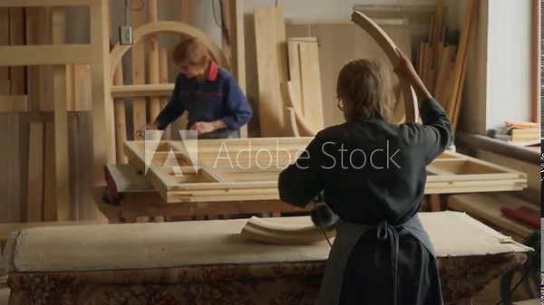 Laborers are working in the window production workshop. Workers grinding and applying putty on window parts in production workshop. Producing wooden windows in the carpentry workshop. Manual Labor.