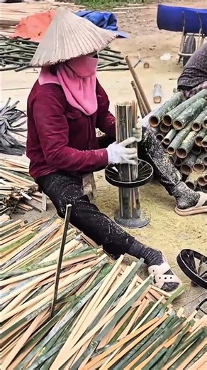 splitting green bamboo into thin strips using a circular manual splitter tool for traditional craft