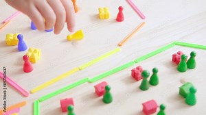 Child and adult enjoy interactive math game with colorful plastic counters and counting sticks, fine motor skills, Early childhood development, Bonding time, Hands-on learning