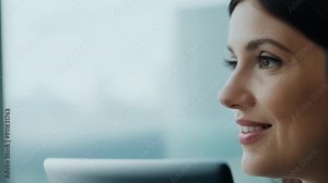 A tight shot of a receptionists face as they politely direct a visitor to the correct office location.