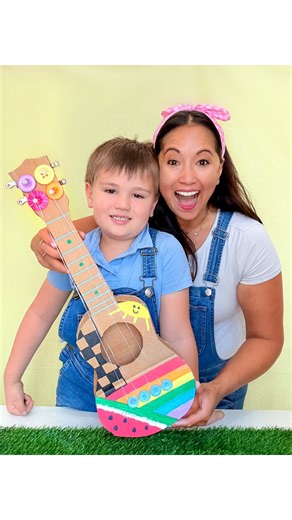 Veena Goel Crownholm on Instagram: "🎸✨ DIY Cardboard Musical Instrument Magic with Max & Me ✨🎸 We got so inspired by the new The Melon Patch YouTube series (by the creators of @CoComelon) and decided to turn that energy into a homemade project with Max. 🎨🧡 All you need is: • A sturdy cardboard box (hello, all those delivery boxes!) • Acrylic paint pens (or regular paint) • Buttons, push-pins, binder clips • Dental floss (for “strings”) • Hot glue, tape • A dash of creativity (and patience 😉