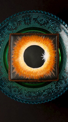 I made two versions of this eclipse cookie. This one is painted with @sweetsticksau edible paint and the other one is decorated with wet-on-wet royal icing. Let me know which version you saw first and which one you like better! #decoratedcookies #icingcookies #sweetambscookies #eclipse2024 | SweetAmbs