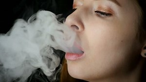 clip-24538718-young-beautiful-woman-smoking-electronic-cigarette-on