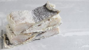 dry salted cod fish on ceramic background