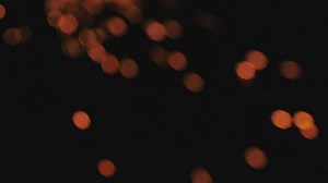 Fire particles on dark background - Free Stock Video