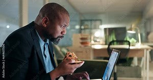 Pizza, night and professional black man on a laptop in the office doing research for a financial project deadline. Fast food, technology and African male accountant eating a dinner meal and working.