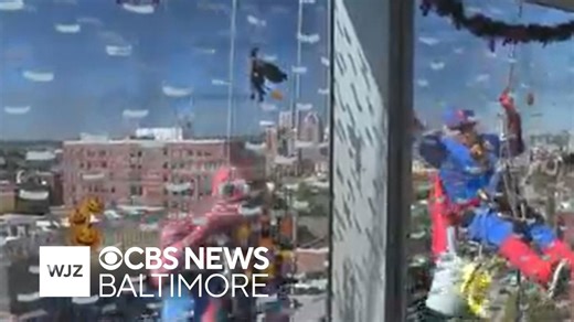 Superhero window washers greet children at Johns Hopkins Hospital