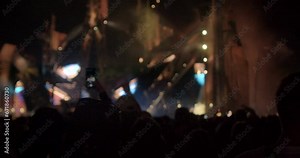 Vibrant colorful light show on scene of musical event, crowd of spectators dancing on dance floor. Bass thumps in perfect rhythm with heartbeats of ravers. Electronic music, all-night dance parties.