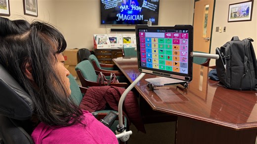 Kaili Webster demonstrates her Tobii Dynavox communication device
