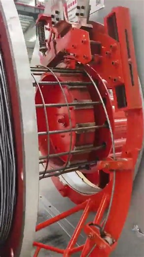 Industrial coiling machine winds steel wire evenly onto large rotating spool #popular #machine