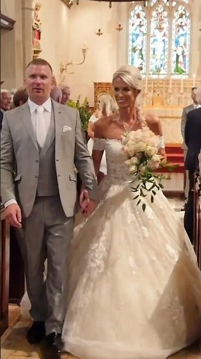 bride and groom walk up the aisle