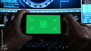 Hackers hands using a smartphone (landscape) in dark office, motion-tracked for easy screen replacement