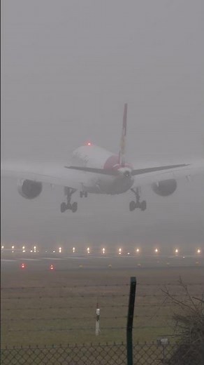 Edelweiss Air airplane Airbus A350-800 HB-IHB landing on a foggy winter day.