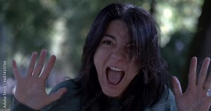 Funny woman reacting with surprise and shock to camera in super slow-motion 800 fps. Exaggerated reaction of person yelling at camera