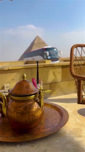 Morning coffee with a 4,500 , year-old view ☕🐫✨ This isn't just breakfast, it's a once-in-a-lifetime moment. Watch the Pyramids glow in the soft morning light while you enjoy traditional Egyptian breakfast or your favorite brew. The desert air is cool, the crowds haven't arrived yet, and you're sitting face-to-face with history. Some people start their day scrolling through their phones. You? You're starting yours at the Pyramids of Giza. ☕ Breakfast with pyramid views 🌅 Best during sunrise ho