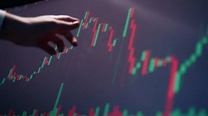 clip-3506111843-concentrated-female-trader-analyzing-graph-chart-stock