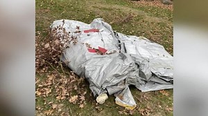 Delta evacuation slide falls off plane and lands in yard