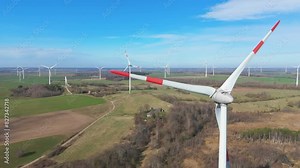 Drone footage of the wind generators in a wind farm in a vast field in Taurage, Lithuania