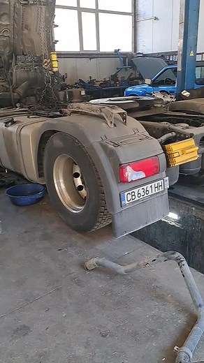 Inside an Automotive Workshop: Repairing a Blue Truck