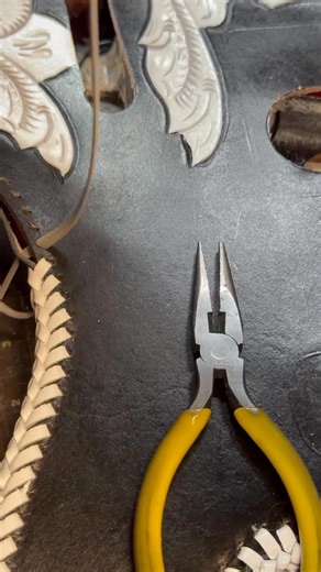 The double loop lacing process. #customleatherwork #customtooledleather #LeatherCraftsmanship #customleather #handmadeleather #leathercraft #leatherstraps | Cody Hixon