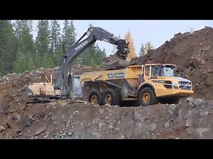 Volvo EC290BLC loading A30G in a quarry