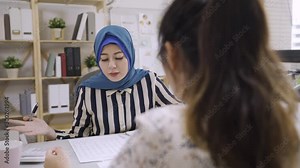 Diverse two asian islam and chinese partners arguing about mistake in document dissatisfied with liabilities fraud having conflict dispute about legal paper bad deal, shouting breaking agreement.