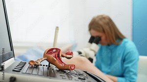 Gynecological office in a modern hospital. The gynecologist uses a colposcope and takes tests from the patient. A woman lies on a gynecological chair during a colposcopy procedure.