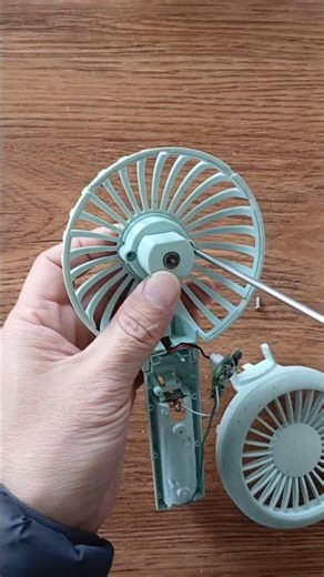 reassemble a mini handheld fan from a pile of old toys