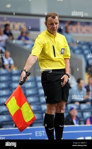 The assistant referee signals for a corner Stock Photo - Alamy