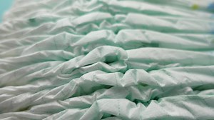 Download Stack of baby diaper on table for free