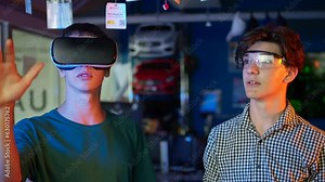 Young engineers with VR virtual reality headset controlling virtual worlds in research laboratory