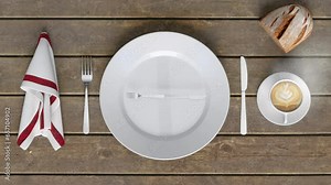 An empty dinner plate on a wooden table with a knife and fork rotating on the plate like the hands of a clock alongside a serviette, a cappuccino, and some homemade brown bread.
