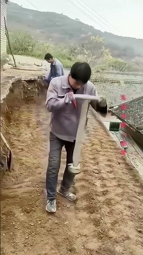 Rural guy uses homemade tool to compact foundation