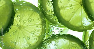 Lime Slices falling deeply under water. Shot on super slow motion camera 1000 fps.