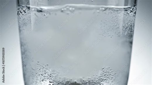 Effervescent Tablet Dissolving in Water A CloseUp View of Bubbles and Fizz Demonstrating Chemical Reaction and Dissolution Process in a Glass of Clear Liquid Ideal for Health Science and Pharmaceutic.