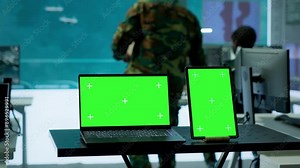 Laptop with green screen display running in military base of operations control tower, space used for gathering intelligence and support secret national defense missions. Command post. Camera A.