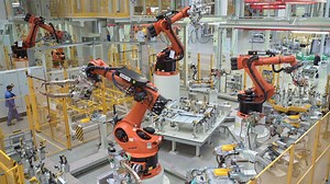Download Russia, Moscow - May 7, 2022. Automated plant with robotics and workers. Scene. Lot of robotic machines create car parts in modern factory. Modern robotic equipment at factory with workers